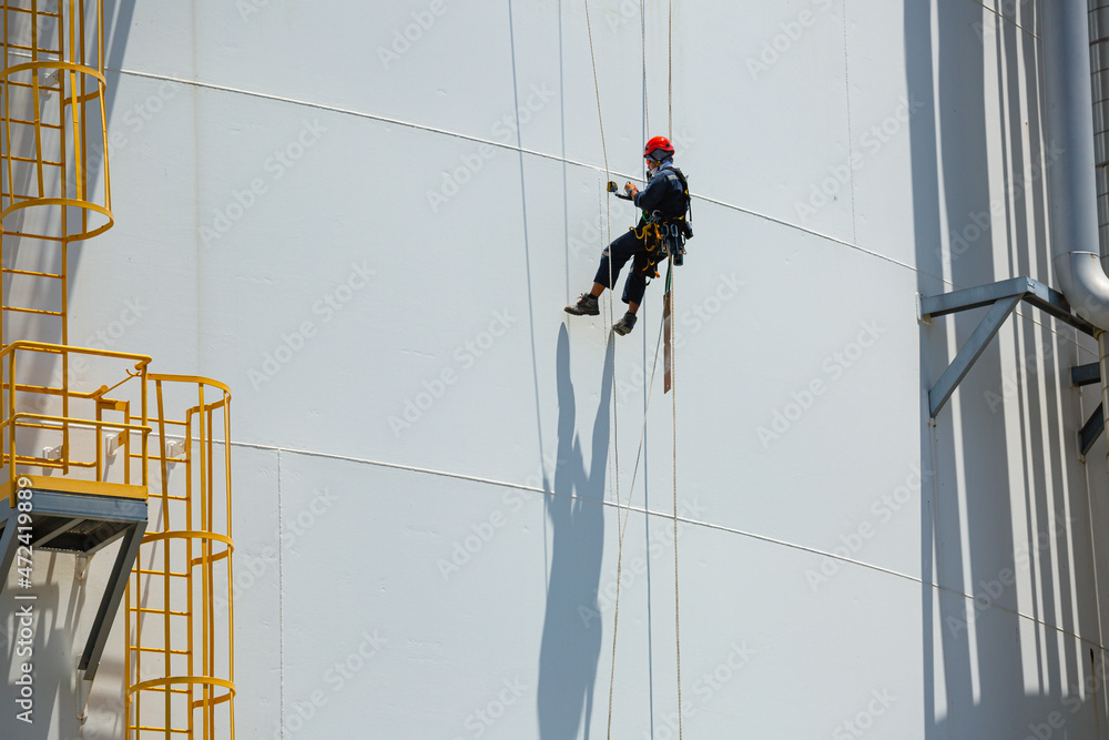 Male worker down height tank shell plate rope ladder access safety ...