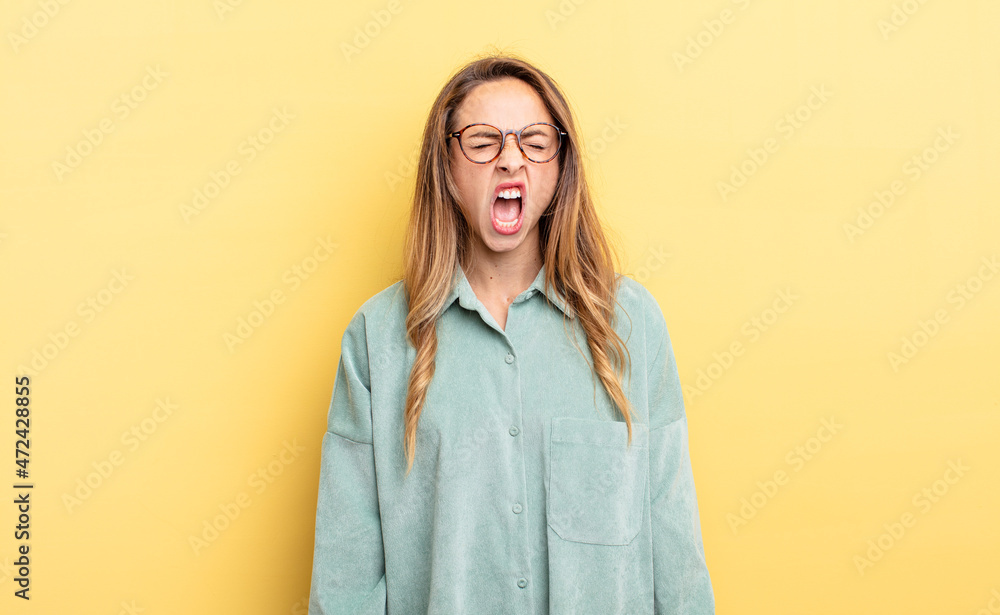 pretty caucasian woman shouting aggressively, looking very angry ...