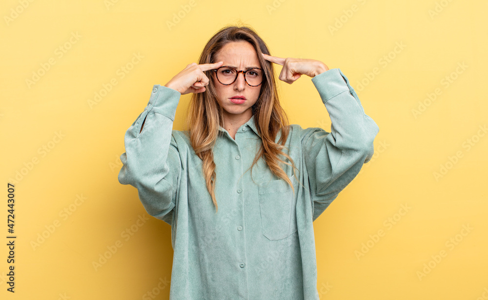 pretty caucasian woman with a serious and concentrated look ...