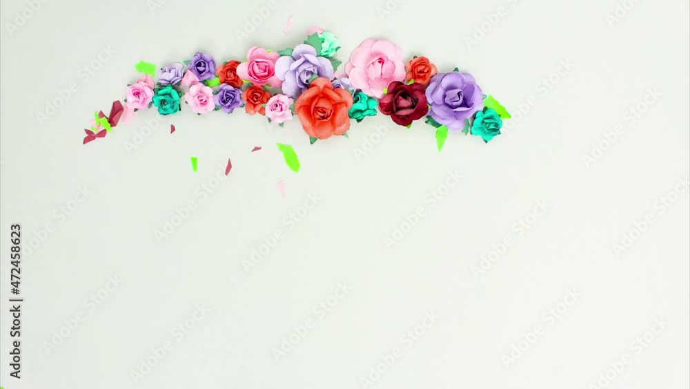 Beautiful assorted multi-colored paper flowers move in a circle in ...