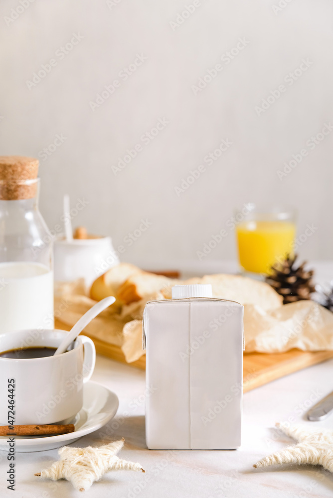 blank half liter milk box packaging with lid on a table with breakfast ...