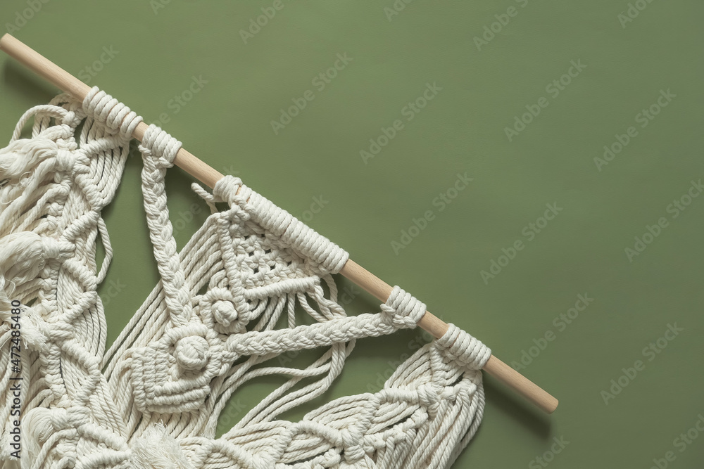 Macrame. Handmade macrame weaving and cotton threads on a rustic wooden ...