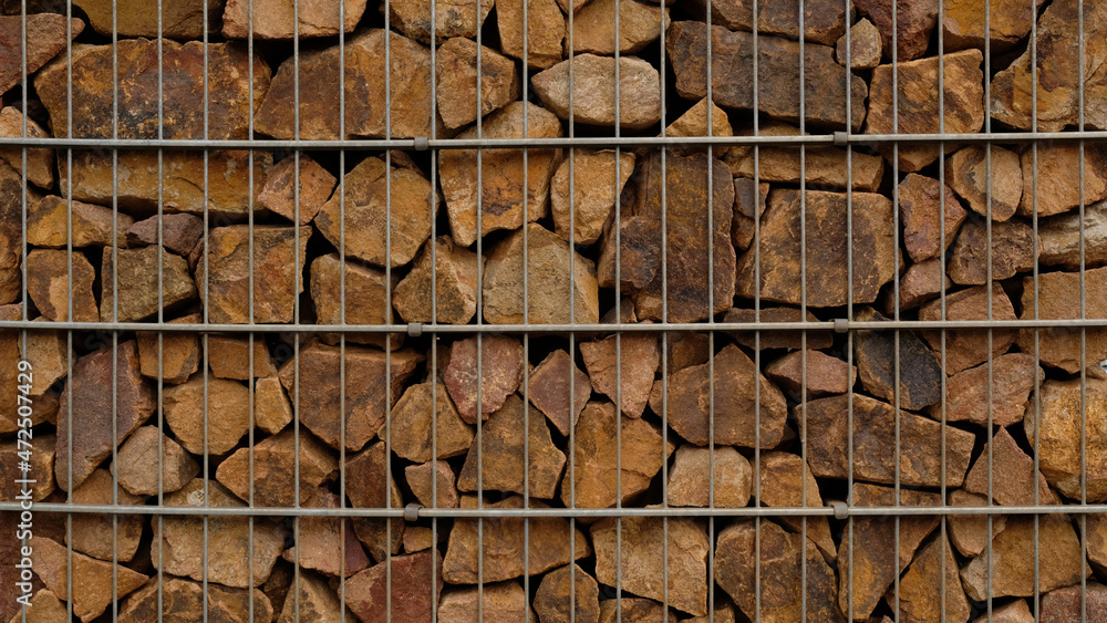 Gabion retaining wall - close-up brown stones in gabion metallic ...