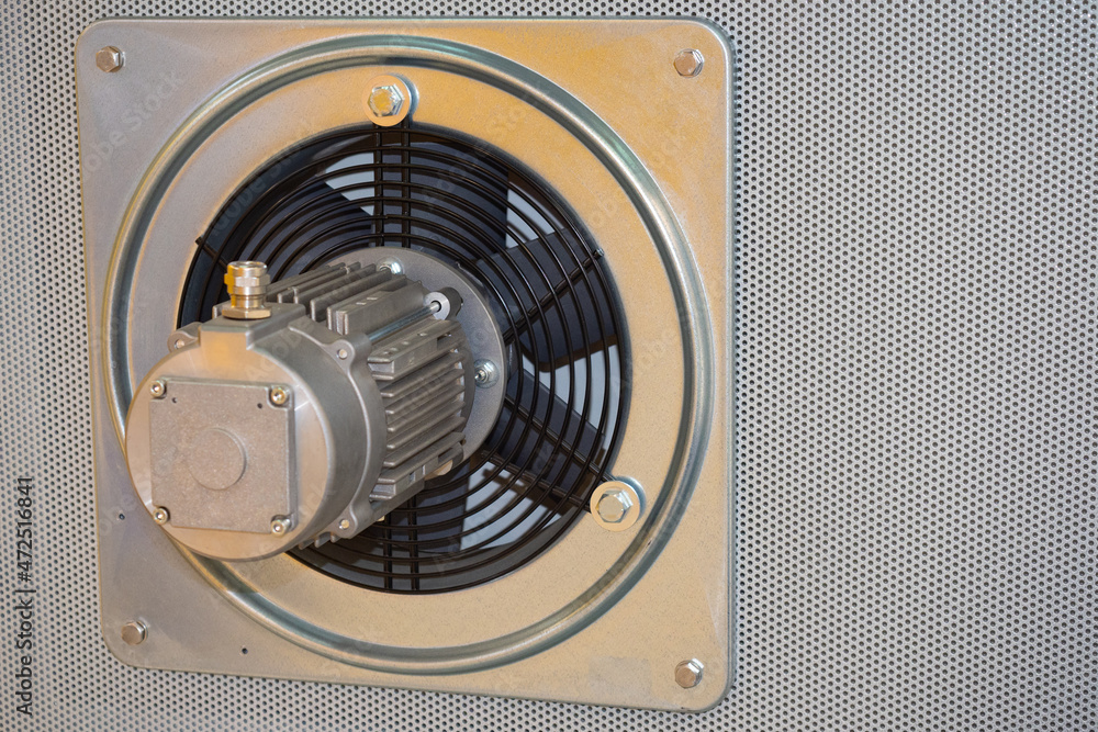 Exhaust fan with built-in electric motor. Exhaust fan on wall of room ...