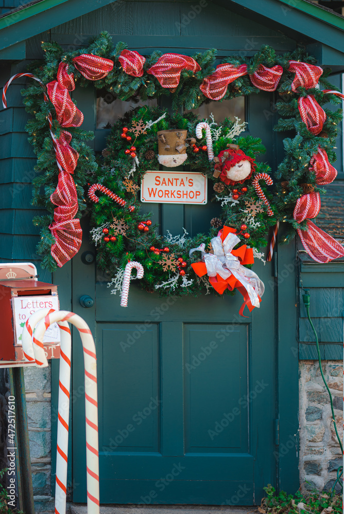 santa's workshop door, decorated with candy canes and red ribbon for ...