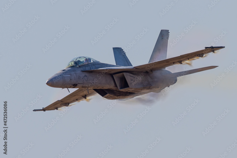 Very close view of a F-18 Hornet approaching in a high G maneuver, with ...