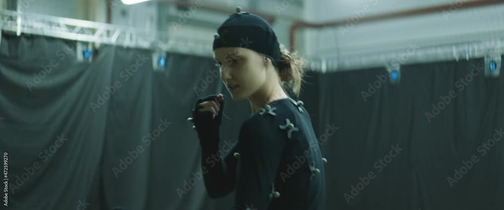 Actors wearing motion capture suits performing some fight moves as game ...
