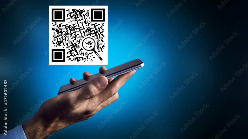 man clicks on the QR code on the phone Stock Photo | Adobe Stock