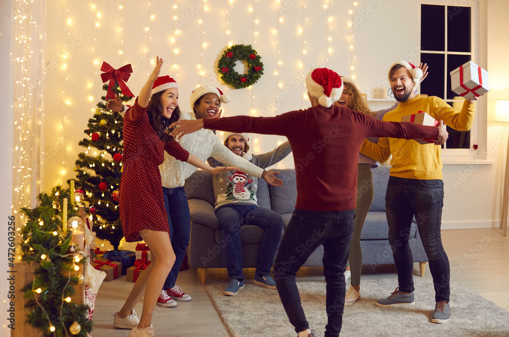 Bunch of mixed race millennial friends reunite at festive get together ...