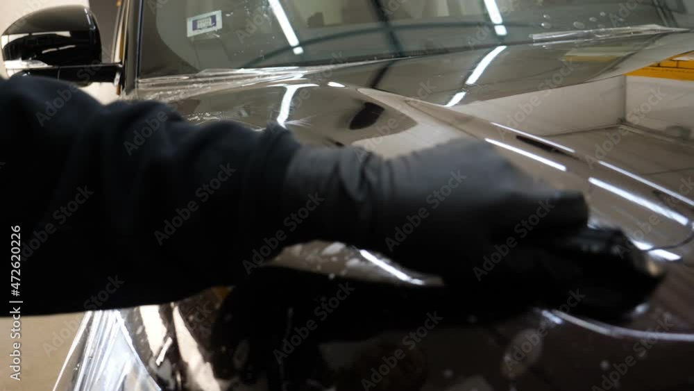 Close up to PPF installation process on a front headlight and hood. PPF ...