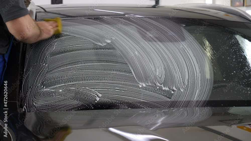 Close up to PPF installation process on a front headlight and hood. PPF ...