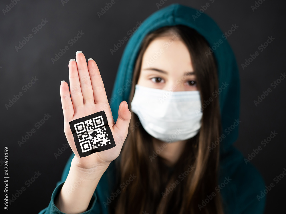 Teenage girl wearing mask for protection against disease shows hand ...