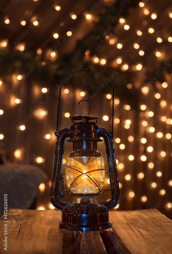 An old-fashioned oil lamp on a background with a bokeh. Kerosene lamp ...