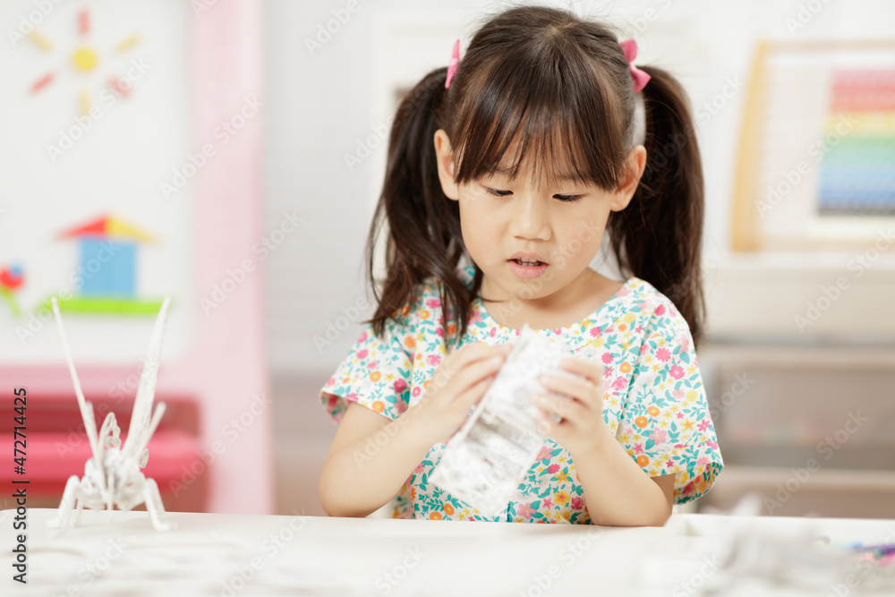 young girl making craft for homeschooling Stock Photo | Adobe Stock