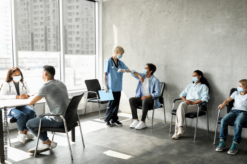 Female doc greeting male patient with elbow bump Stock Photo | Adobe Stock