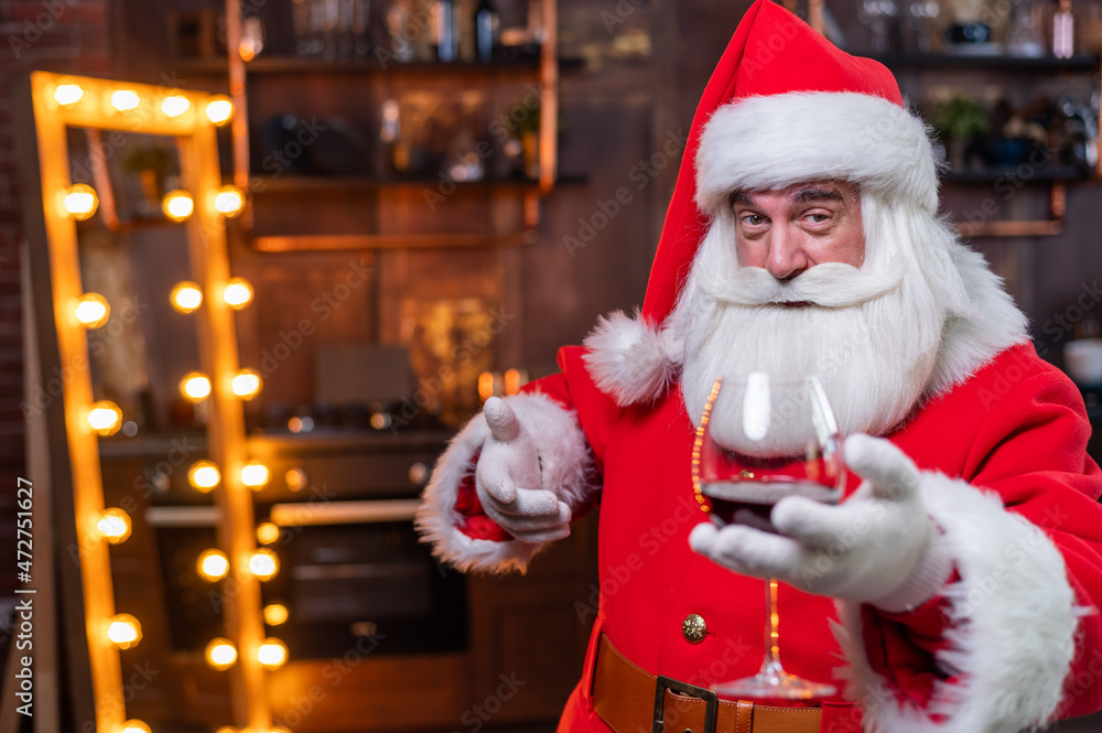 Santa claus with a glass of red wine wishes merry christmas and says ...