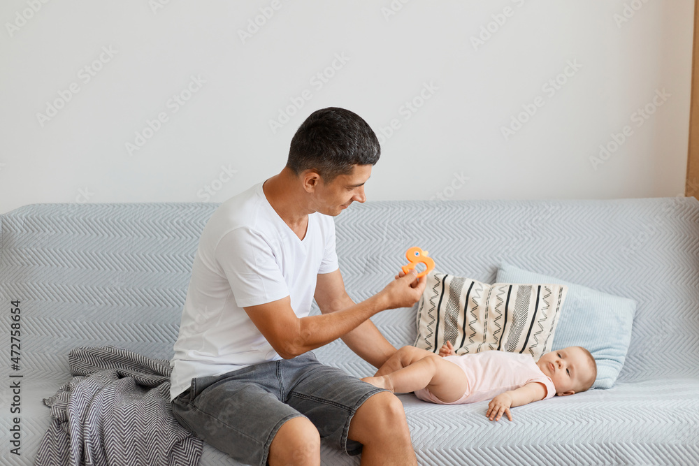 Good looking Caucasian attractive young adult man sitting sofa and ...