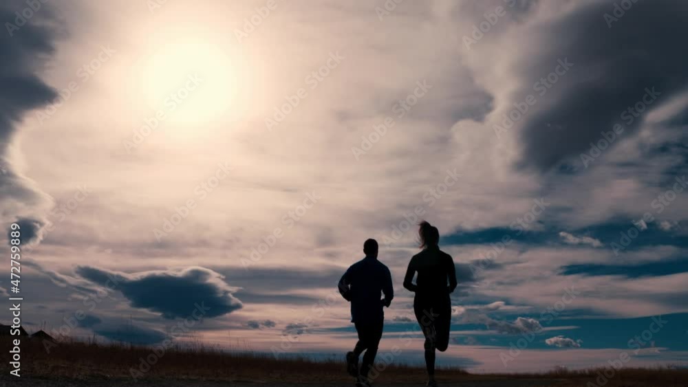 Striking black silhouette outline of a male and female jogger, jogging ...