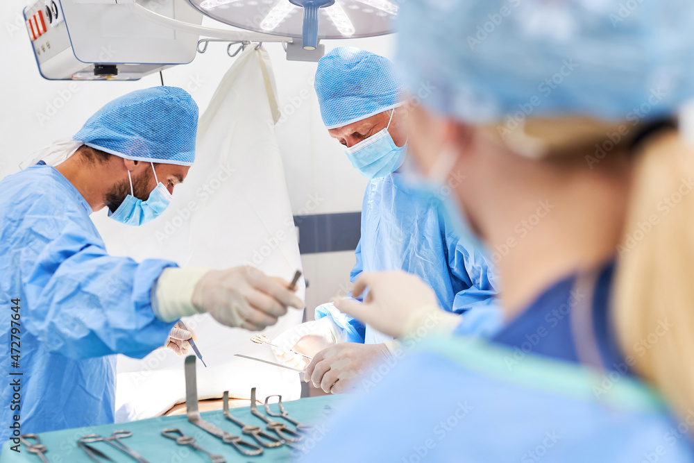 Surgery team works together during an operation Stock Photo | Adobe Stock