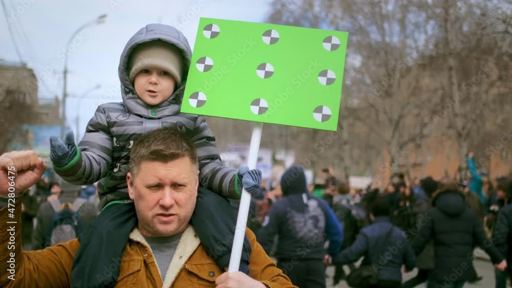 Family of protesting father and son with chroma key space banner ...
