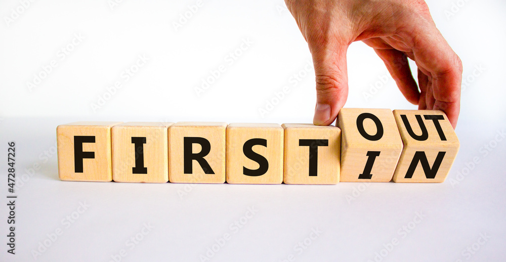 First in first out symbol. Businessman turns wooden cubes and changes ...