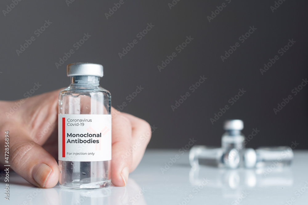 Female doctor hold a vial of monoclonal antibodies a treatment for the ...