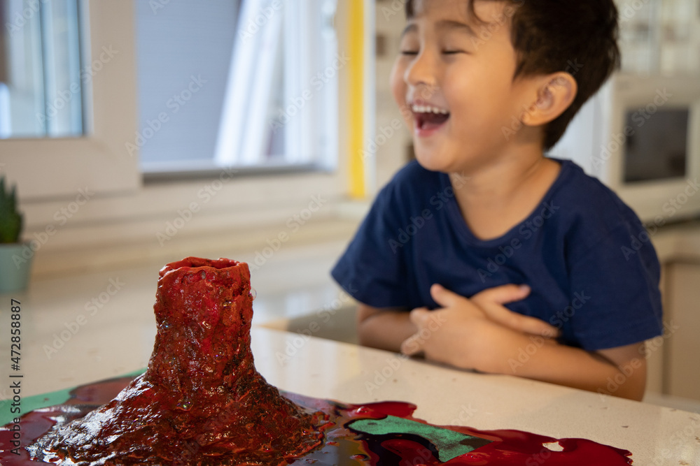 Happy cute boy experimenting with volcano eruption Stock Photo | Adobe ...