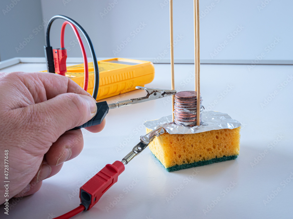 Measuring electric voltage on Volta's pile made from a stack of copper ...