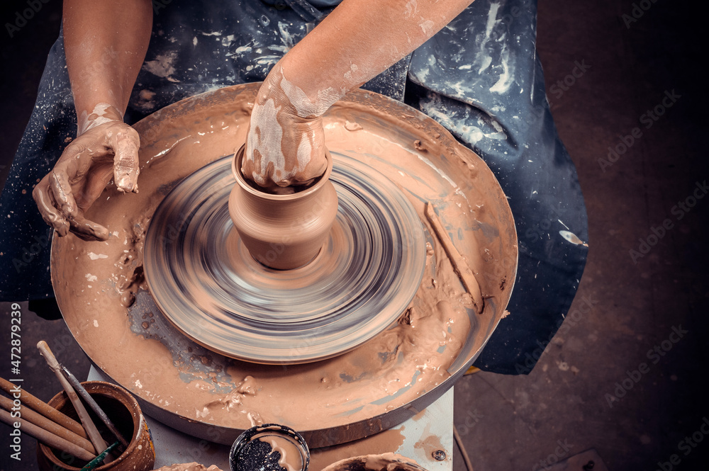 production process of pottery. Forming a clay teapot on a potter's ...