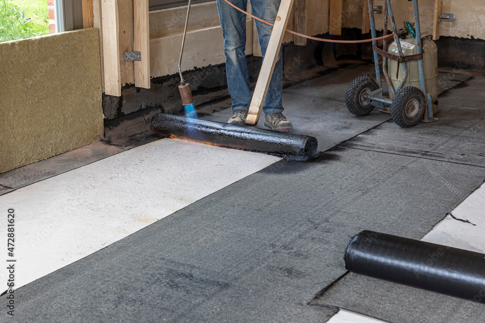 Installation of waterproofing on the concrete foundation by heating and ...