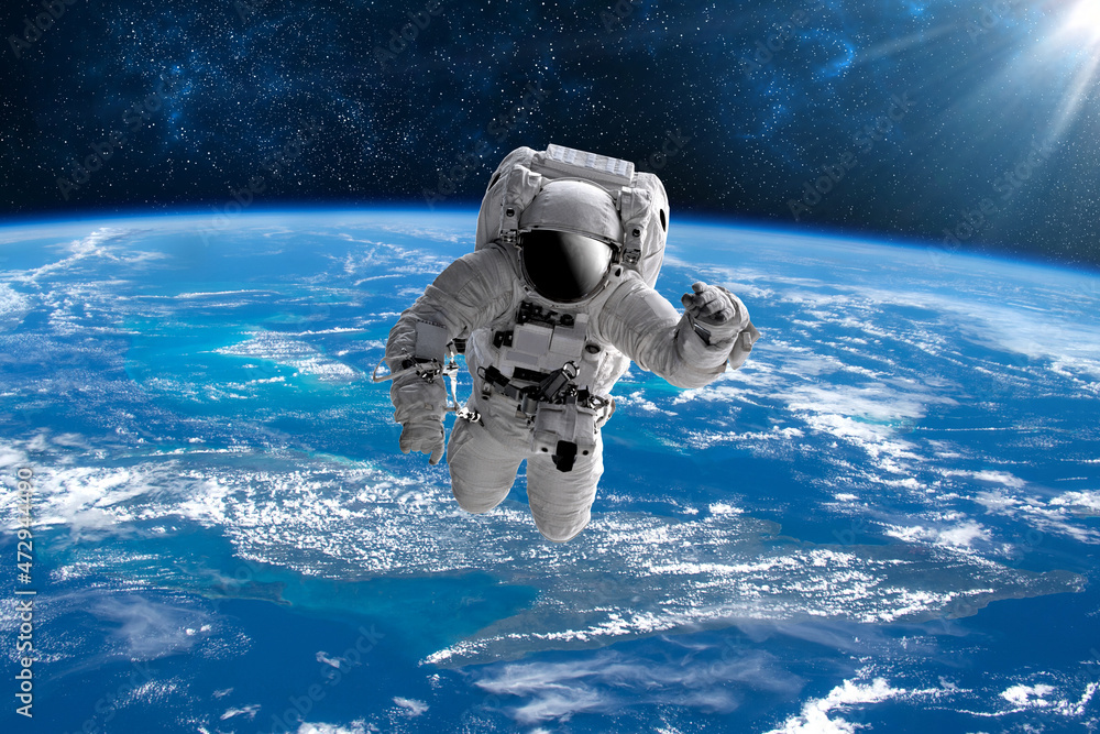 Astronaut in outer open space over the planet Earth.Stars provide the ...
