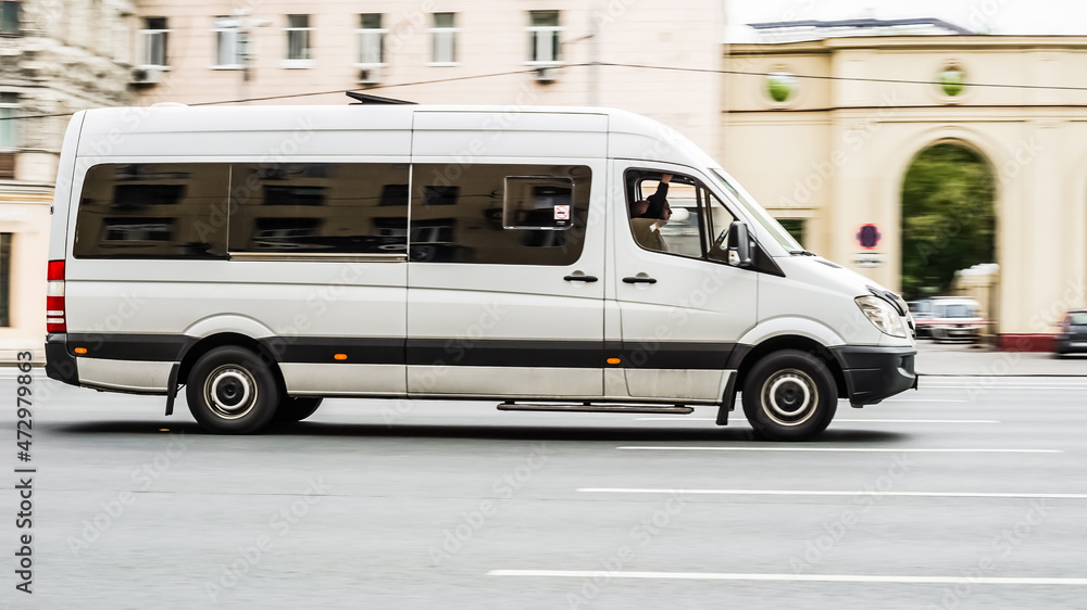 Foto Stock White Mercedes-Benz Sprinter van vehicle on city road. Fast ...