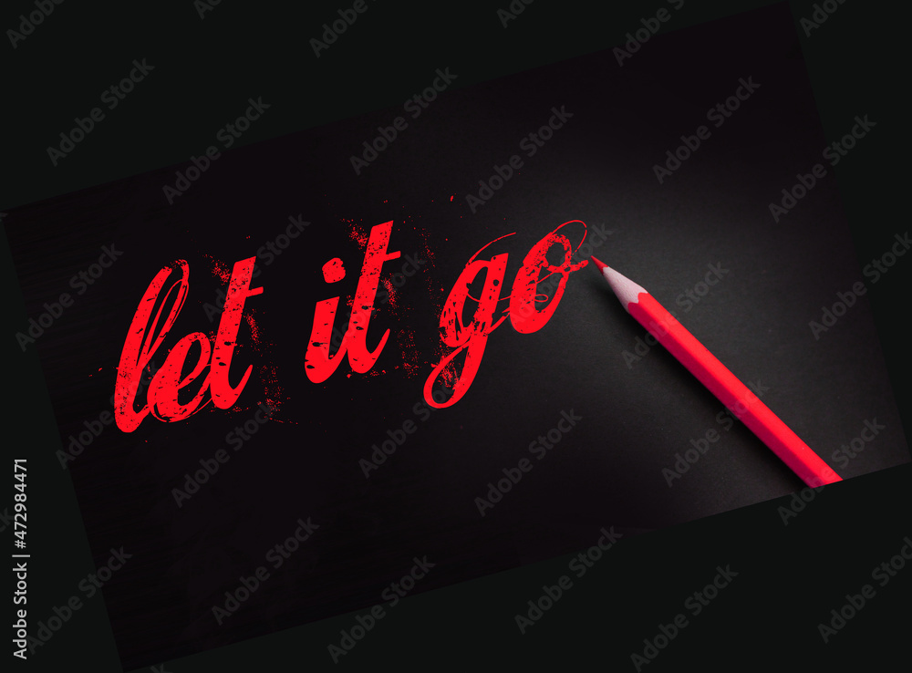 Let it go words written with a yellow pencil on black. Forgiveness ...