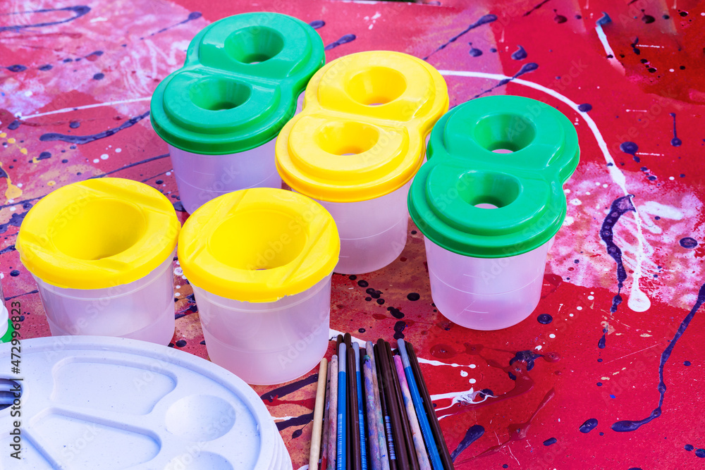 water tanks..brushes, background. Jars with different paints. Objects ...