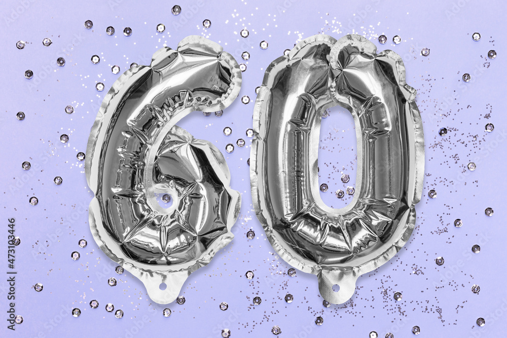 Silver foil balloon number, digit sixty on a lilac background with ...