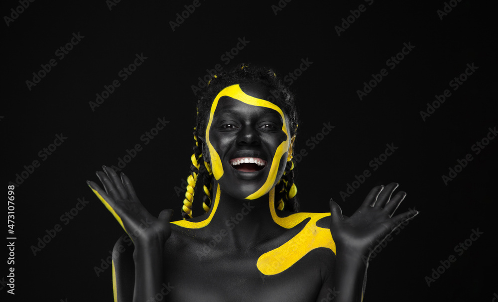 Woman on poster with gold face art. Yellow and black colors of body ...