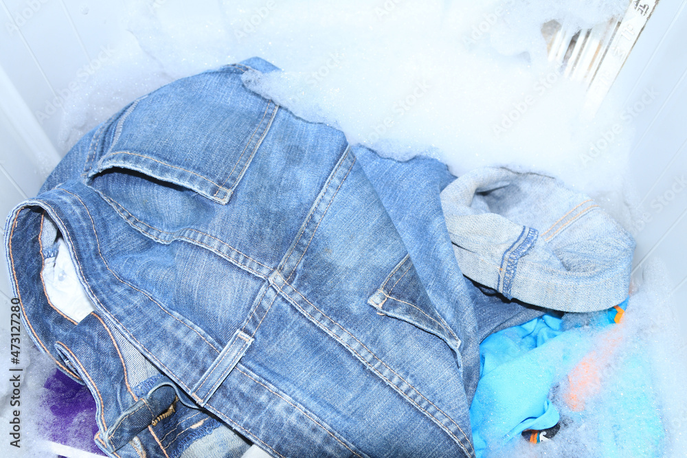 Washing a variety of clothes, including jeans, thoroughly with ...