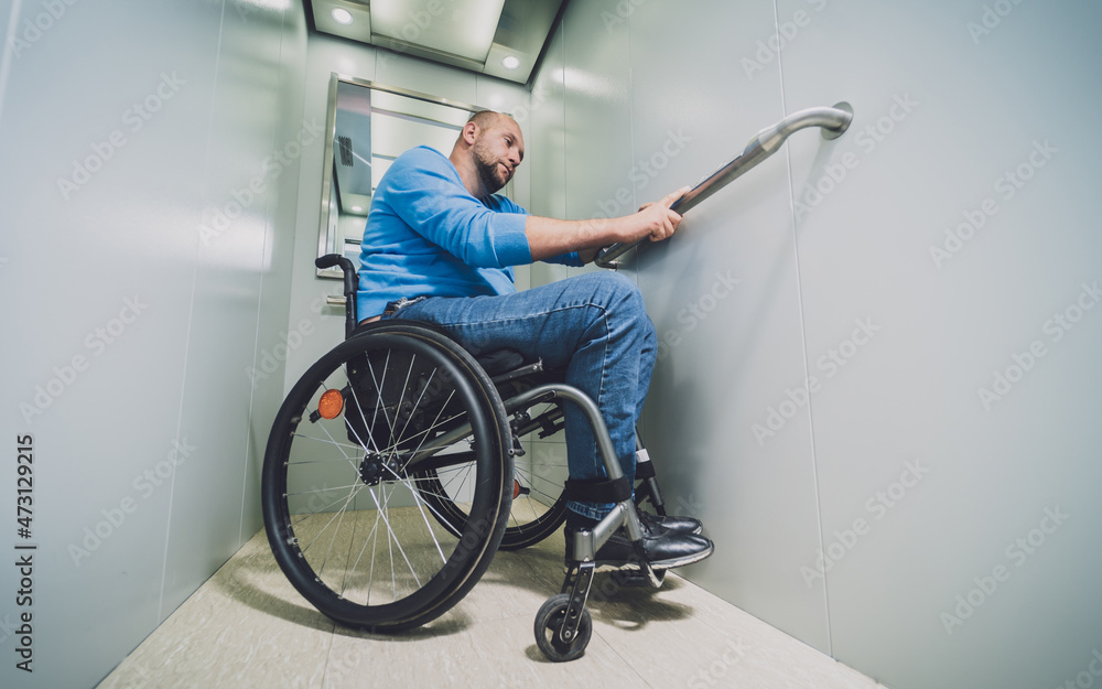 Person with a physical disability in a wheelchair using lift in ...