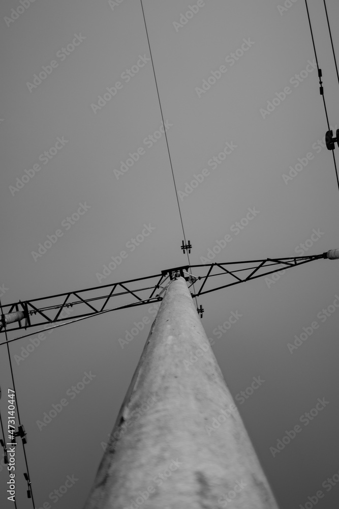 High voltage tower with power lines. View from bottom to on the top of ...