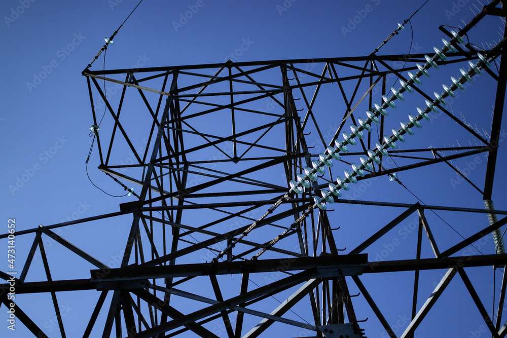 High voltage tower with power lines. View from bottom to on the top of ...