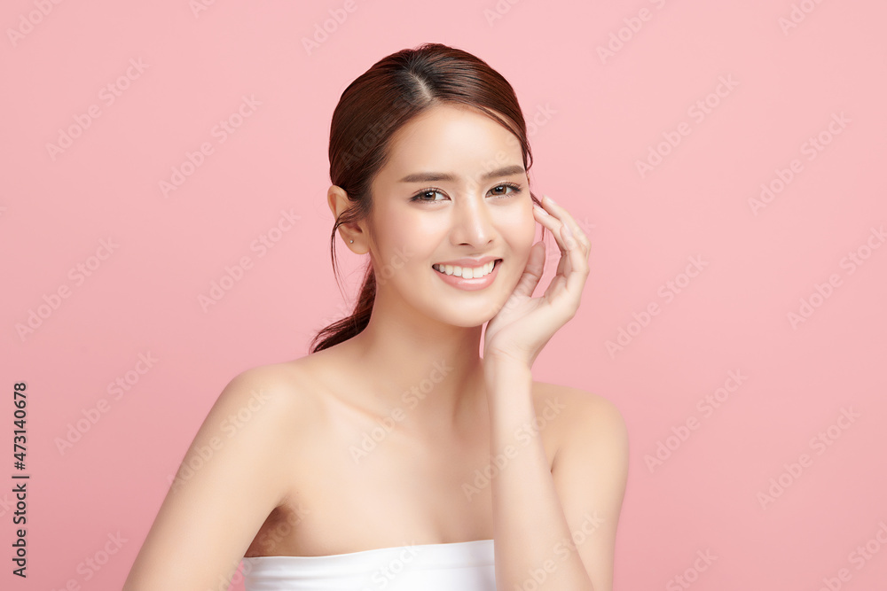 Beautiful young asian woman with clean fresh skin on pink background ...