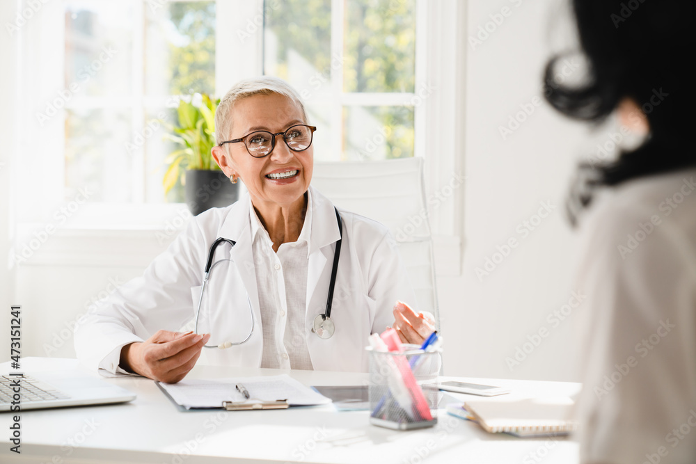 Happy confident senior female doctor gynecologist general practitioner ...