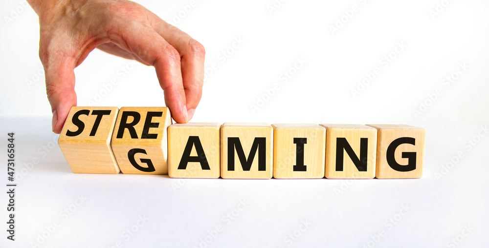 Gaming and streaming symbol. Businessman turns wooden cubes and changes ...