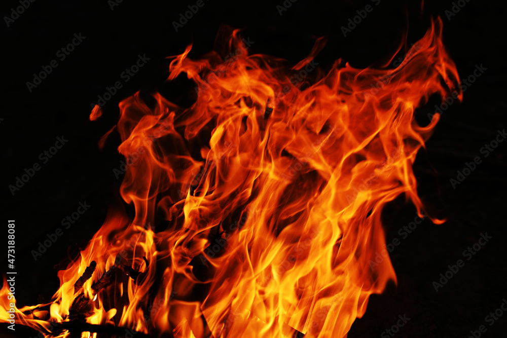 Fire creates infinity shapes when it burns. The orange from the flame ...