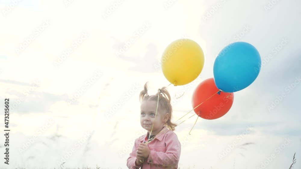 daughter little girl fun runs with balloons a on her birthday outdoors ...