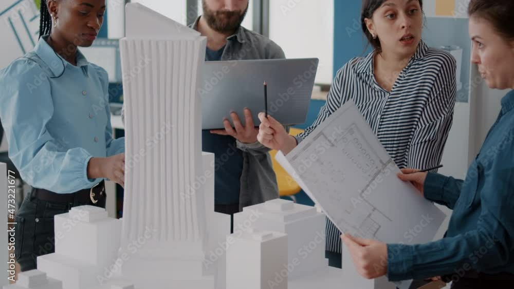 Team of diverse people working together to design building model and ...