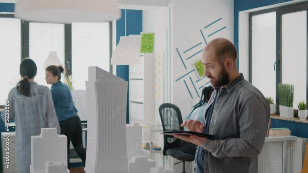 Expert contractor working on building model and design on digital ...