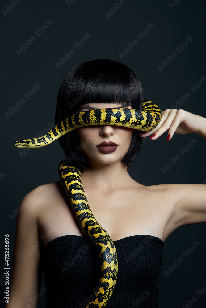 Beauty woman short haircut python yellow snake on her neck. A yellow ...