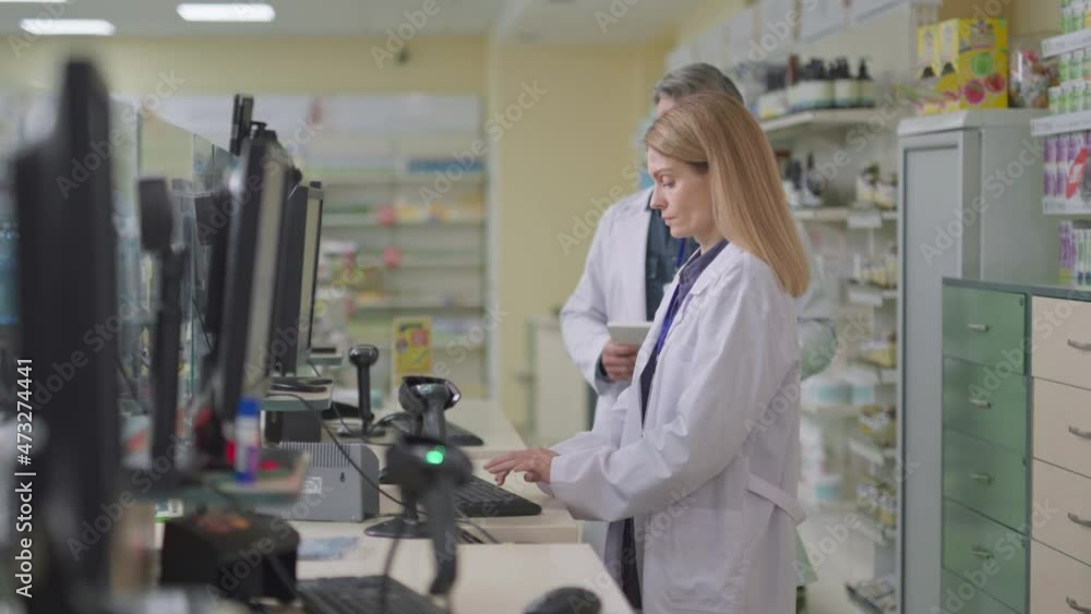 Two professional pharmacy colleagues learning drugs and making medical ...