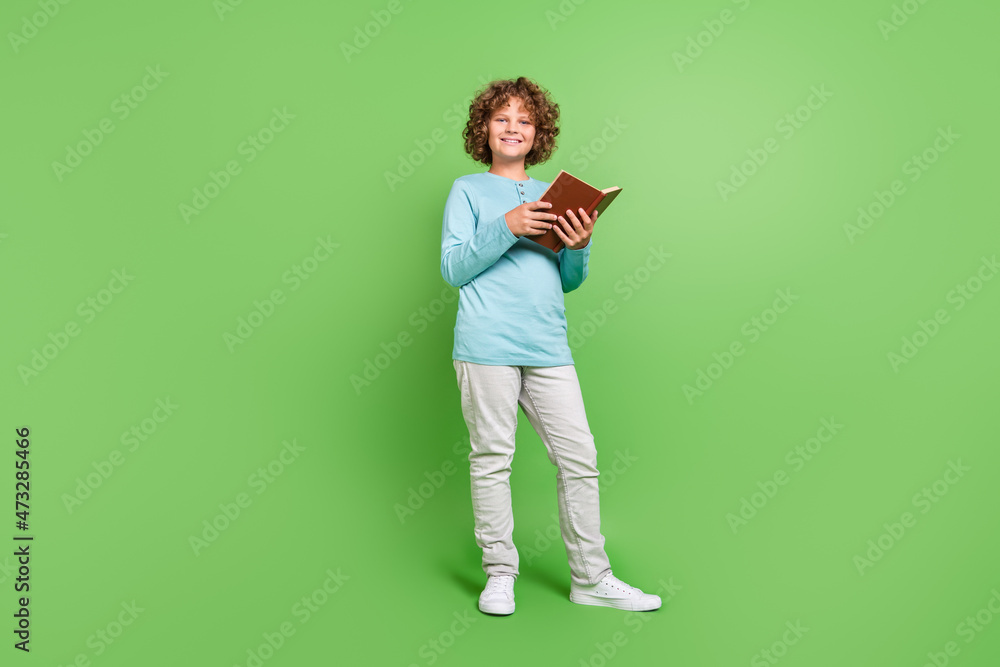 Full length body size view of attractive cheerful guy reading diary ...